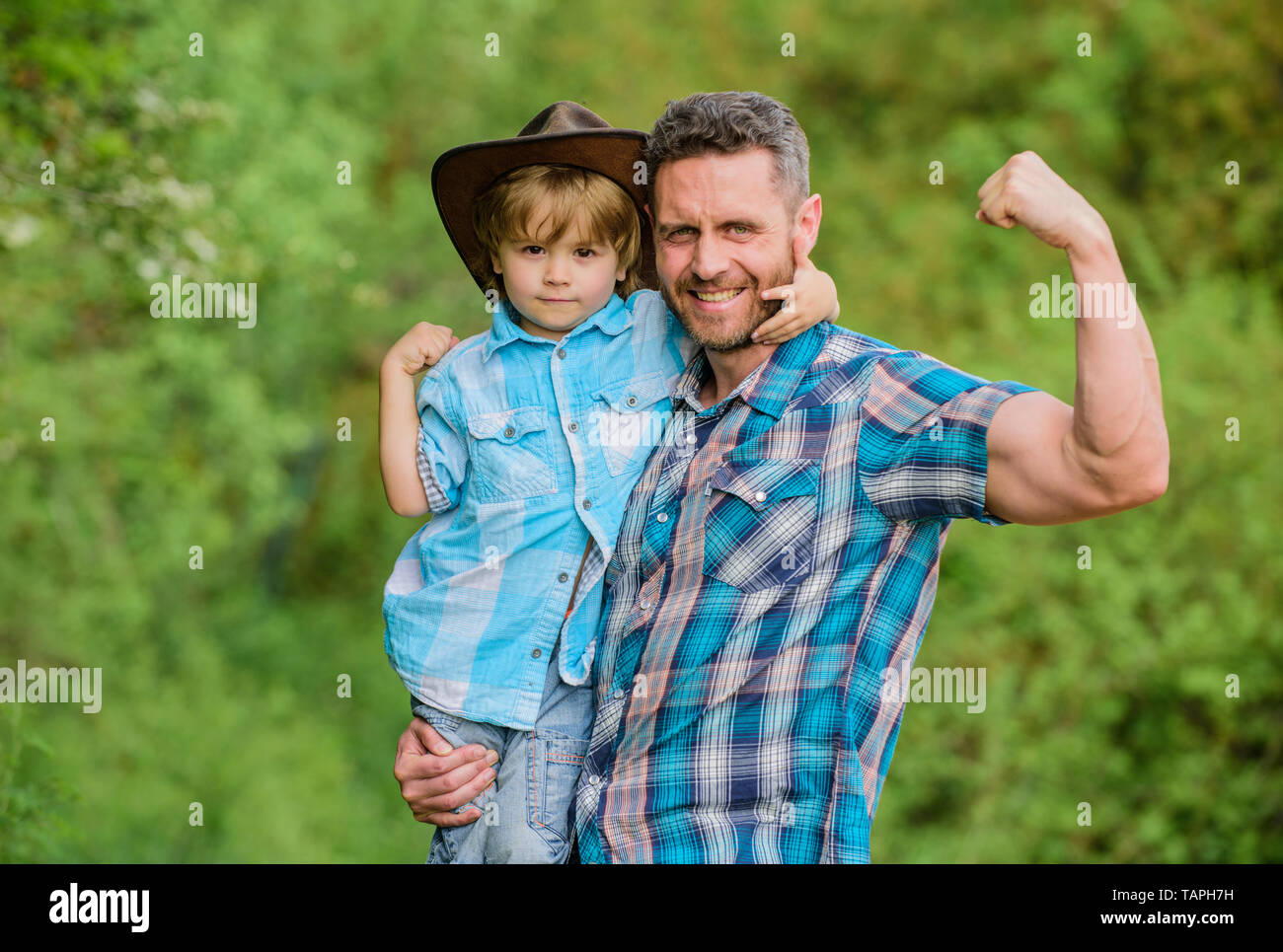 Rustic family. Growing cute cowboy. Small helper in garden. Little boy ...
