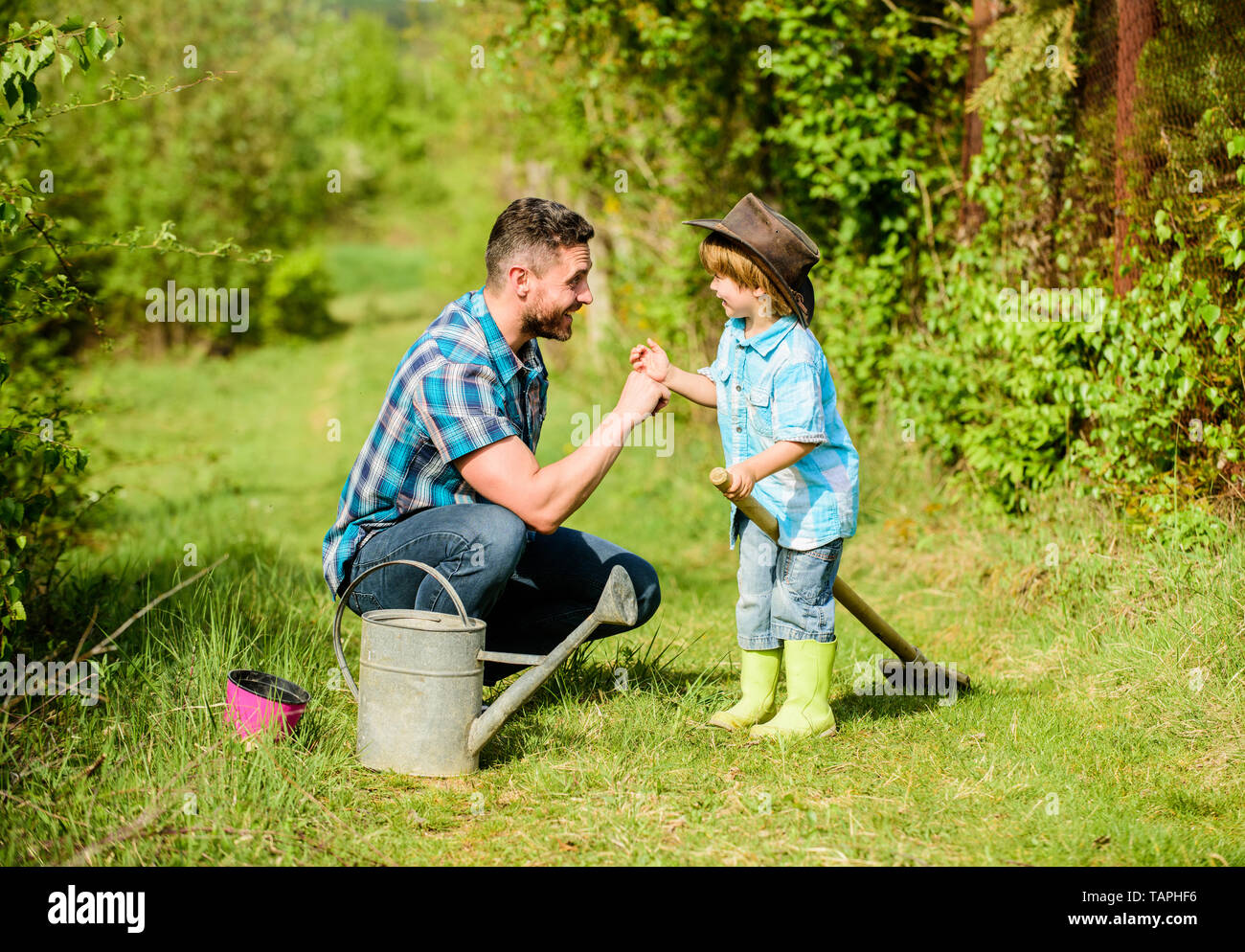 Eco farm. watering can, pot and shovel. Garden equipment. small boy ...