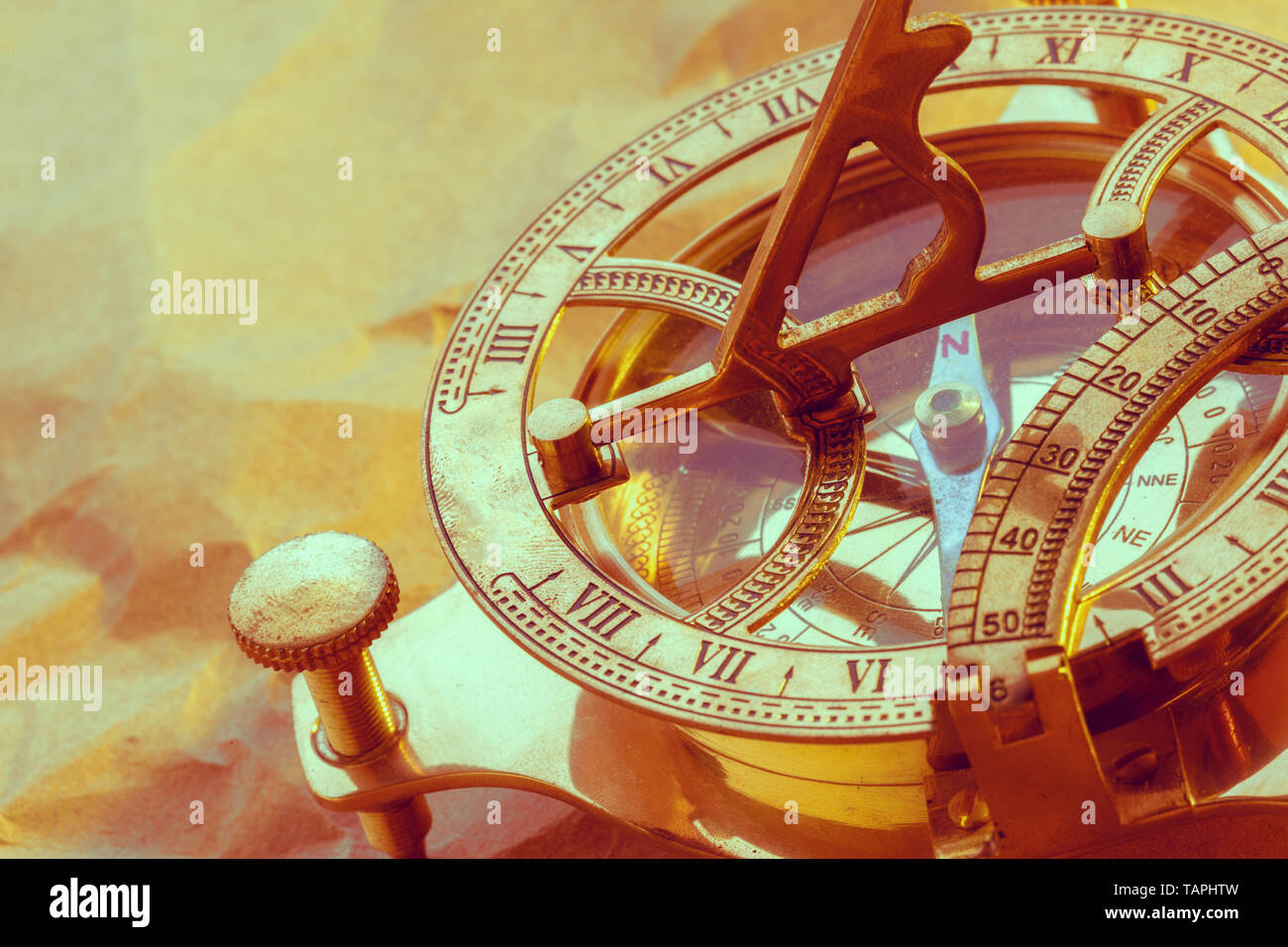 antique compass on vintage paper background Stock Photo - Alamy