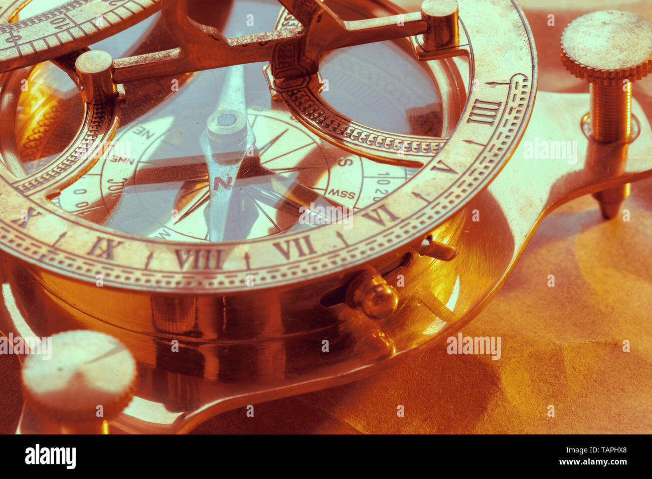 antique compass on vintage paper background Stock Photo - Alamy