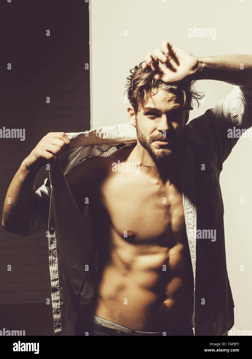 Handsome man shows muscle torso Stock Photo - Alamy