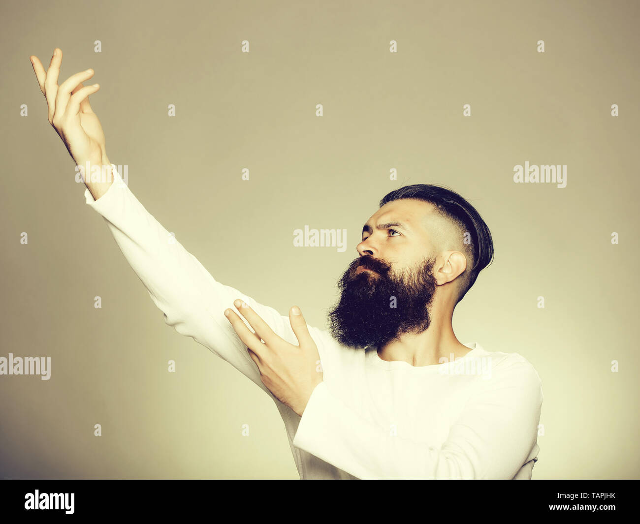 Bearded man with raised hands Stock Photo - Alamy