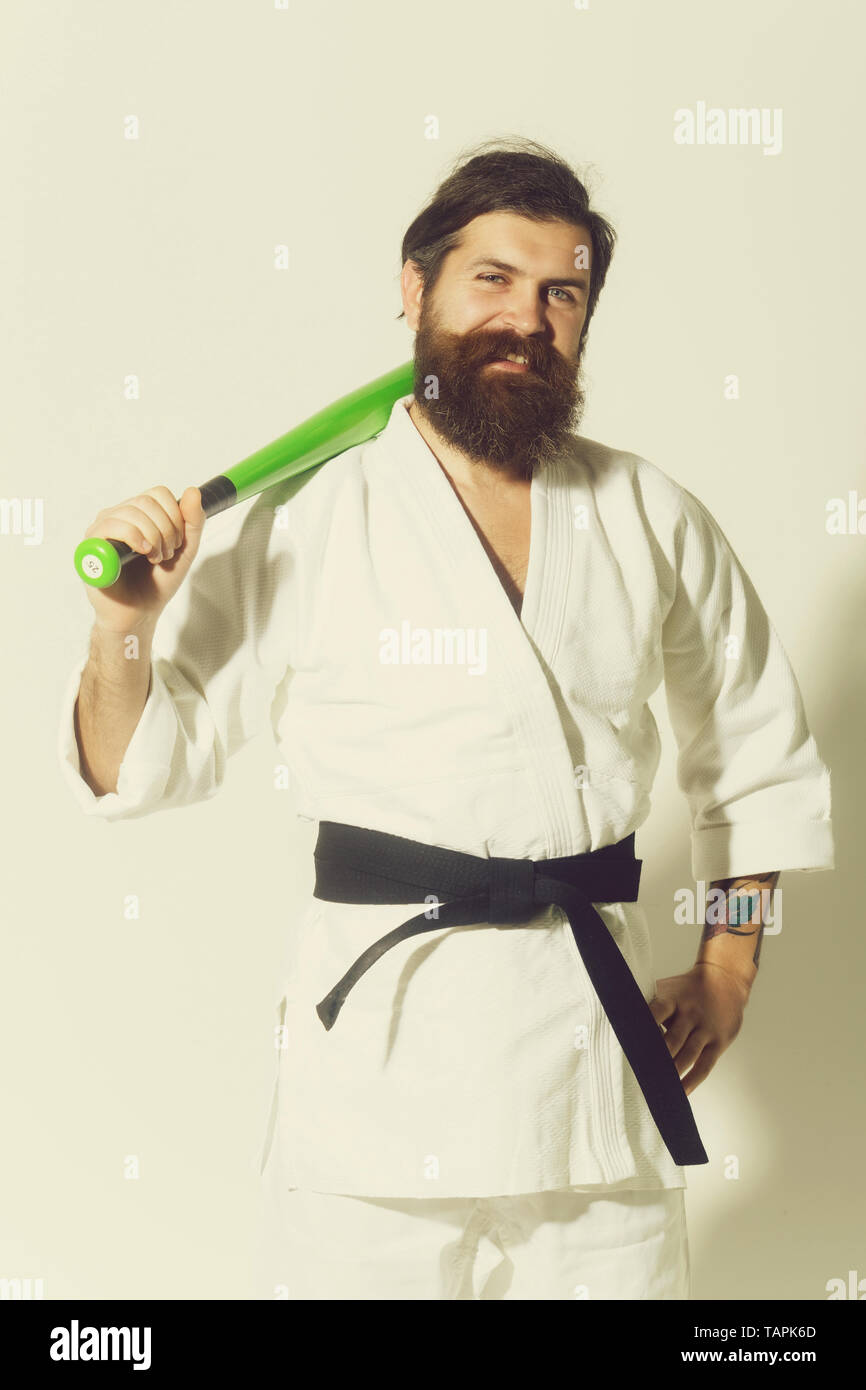 bearded smiling karate man in kimono with green baseball bat Stock ...