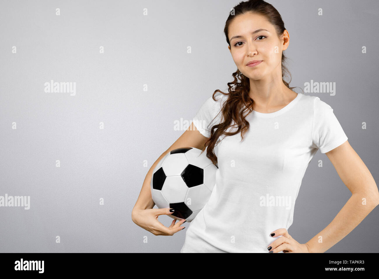 young woman holding soccer ball on her hand Stock Photo - Alamy