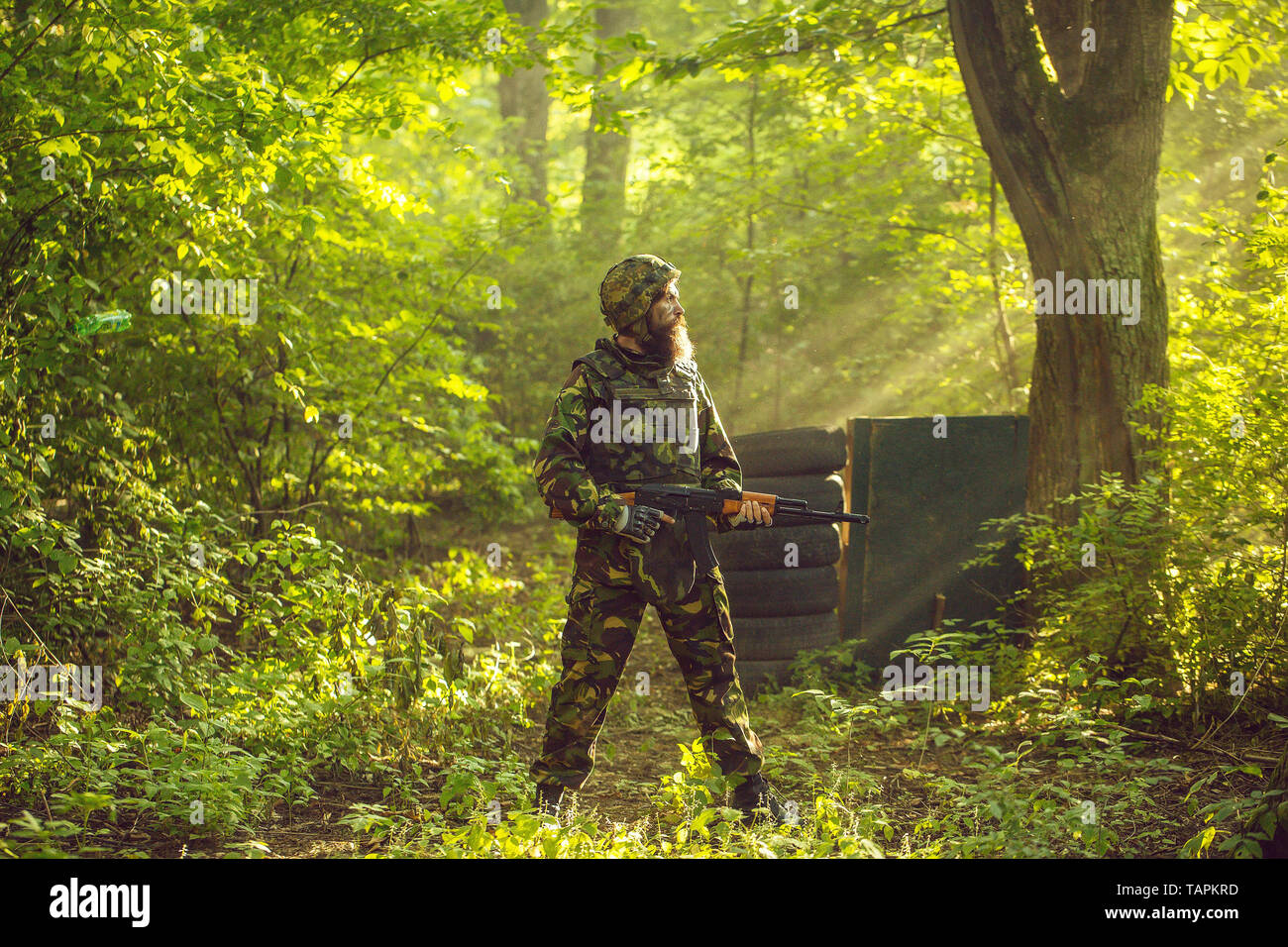 Soldier with rifle in forest Stock Photo - Alamy