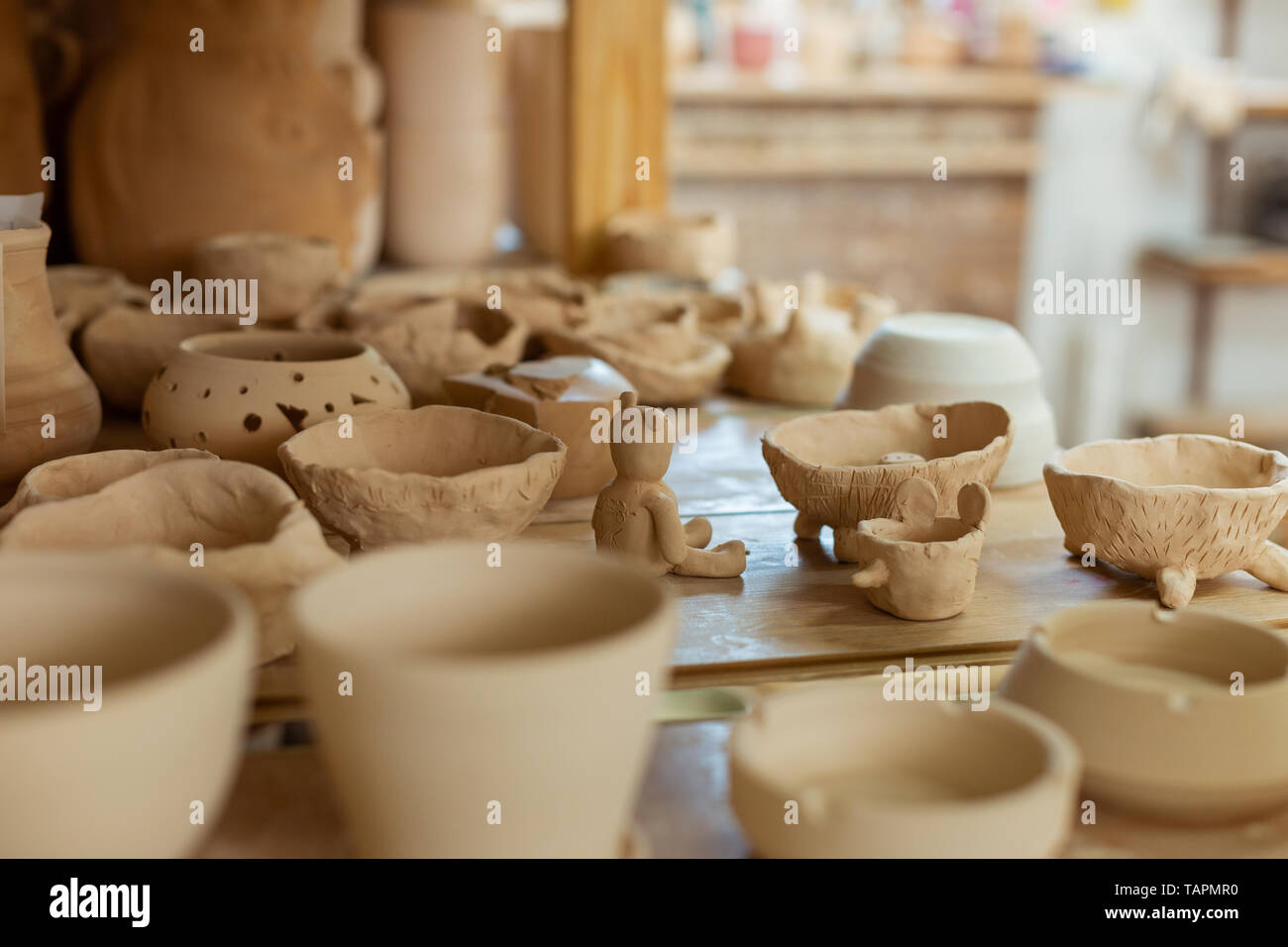 Pottery collection. Bunch of fresh unprocessed clay pots placed on a ...