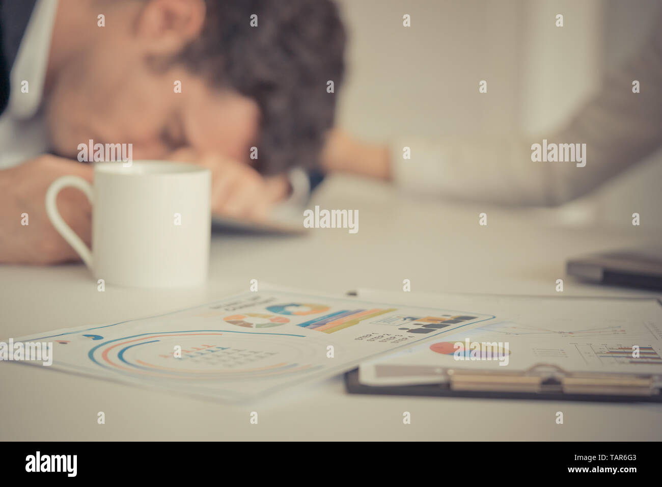 Tired business man fall asleep on office table Stock Photo - Alamy