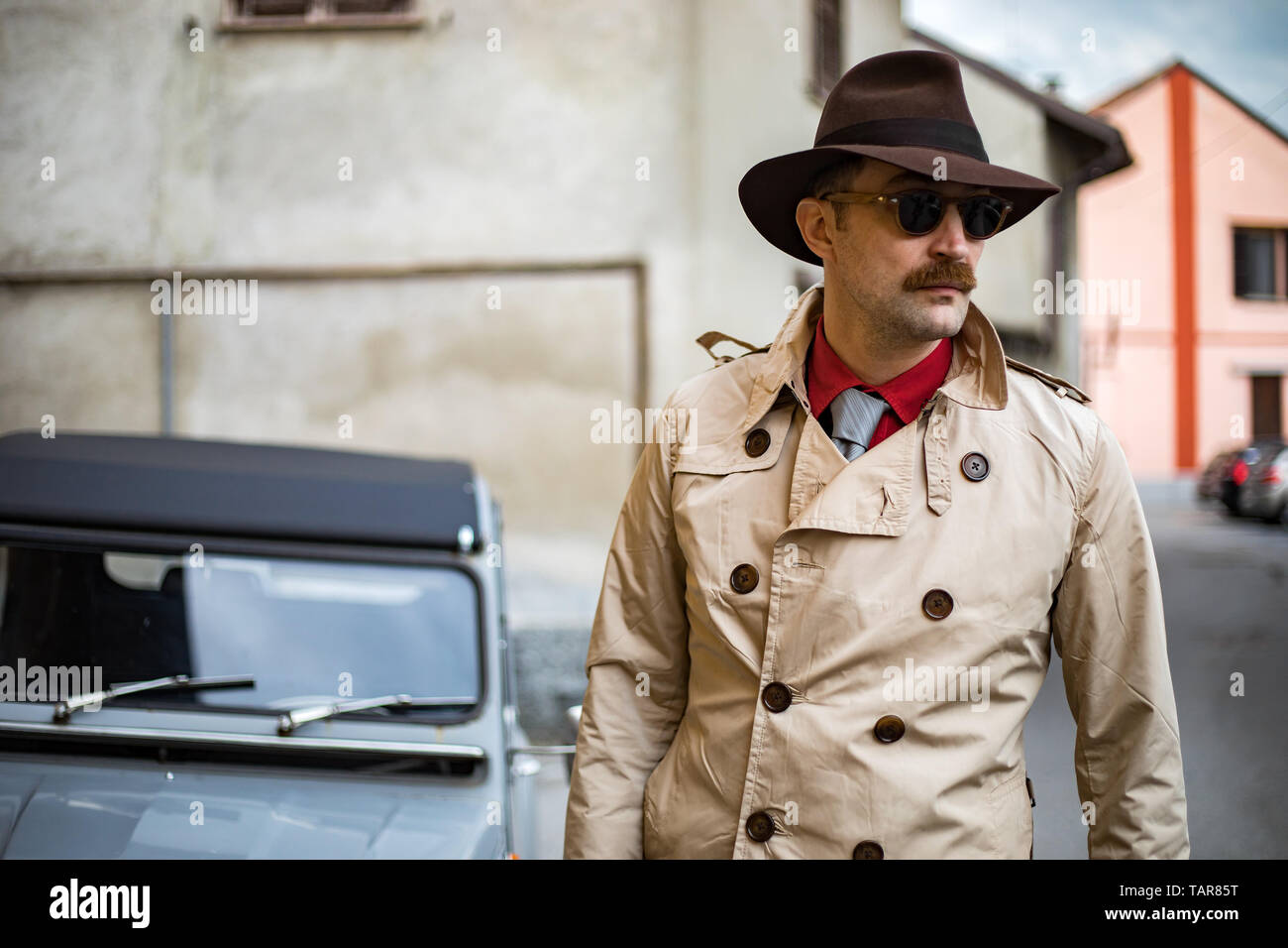 Detective walking in the city slums Stock Photo - Alamy