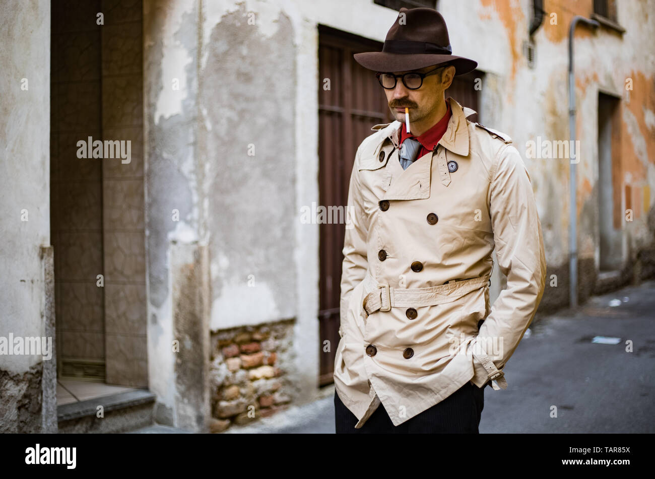 Detective walking in the city slums Stock Photo - Alamy