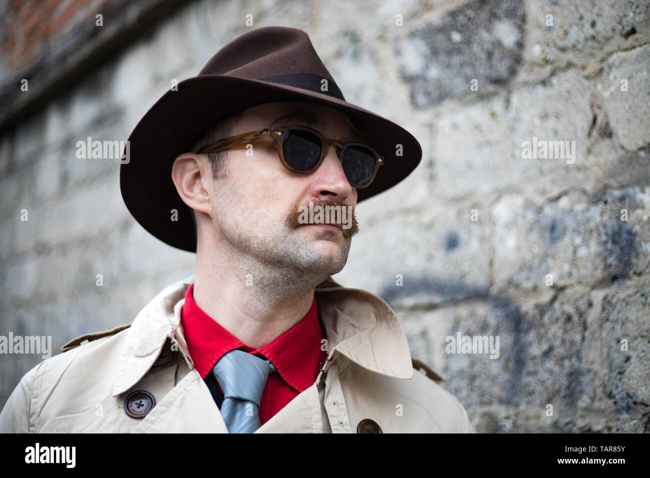 Detective walking in the city slums Stock Photo - Alamy