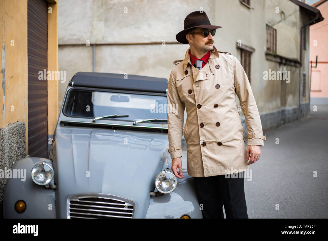 Detective walking in the city slums Stock Photo - Alamy