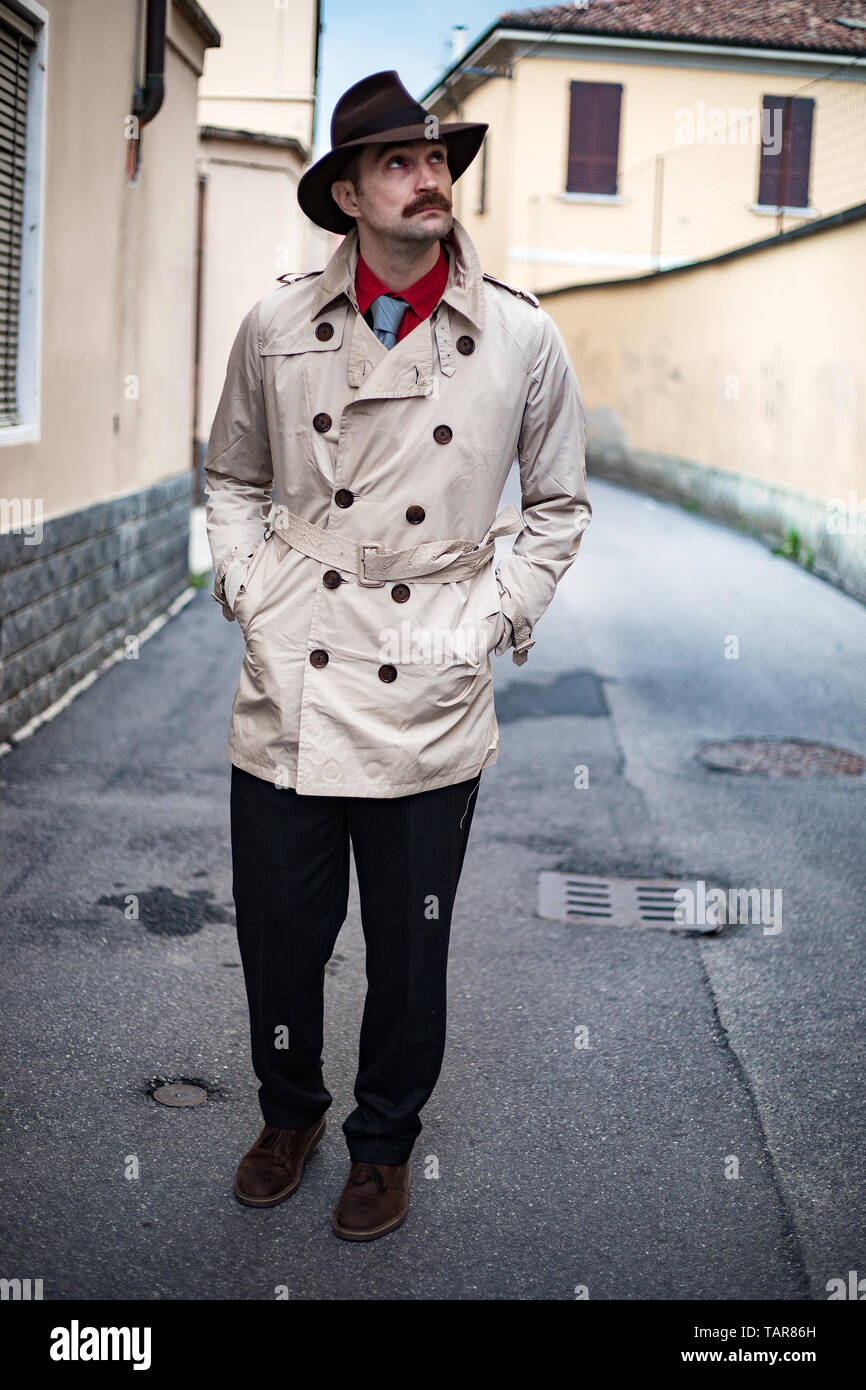 Detective walking in the city slums Stock Photo - Alamy
