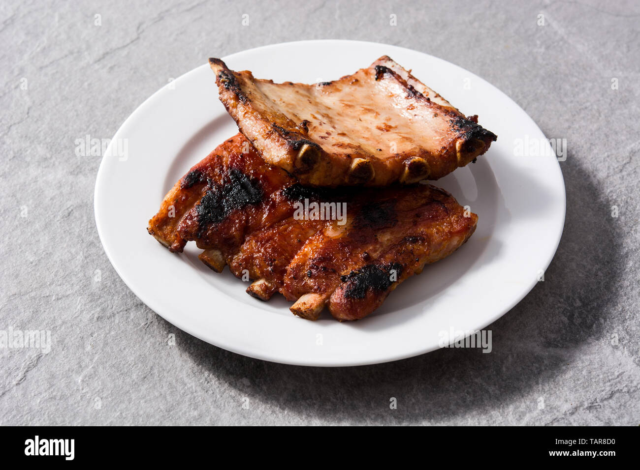 Grilled barbecue ribs on gray stone background Stock Photo - Alamy