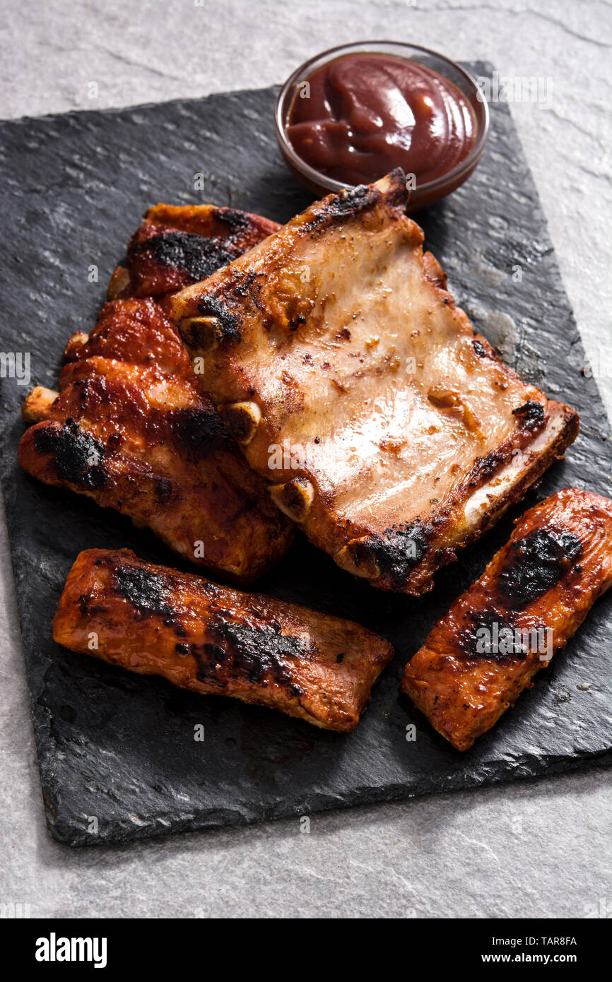 Grilled barbecue ribs on gray stone background Stock Photo - Alamy