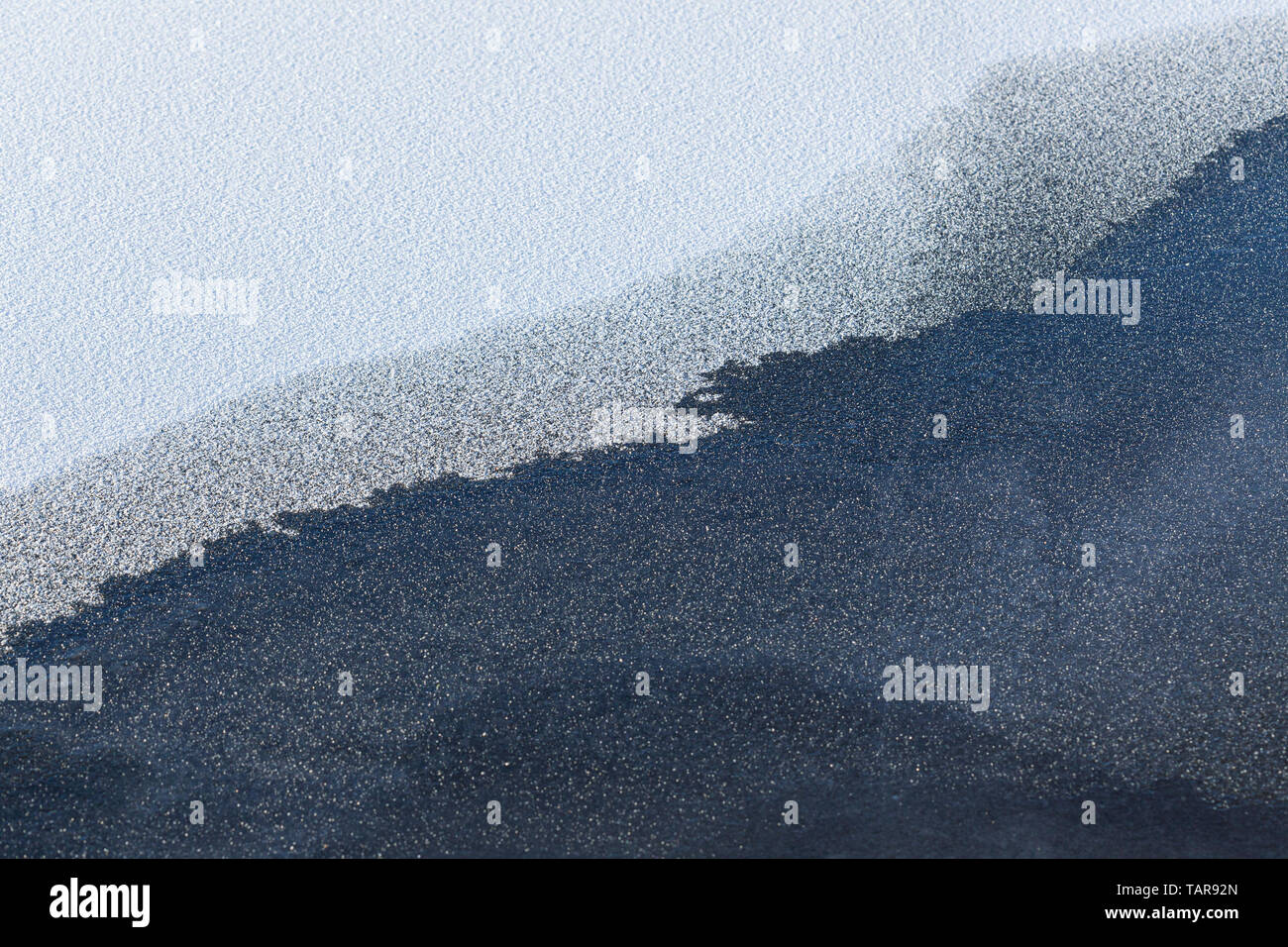 Snow on frozen lake ice surface background Stock Photo - Alamy