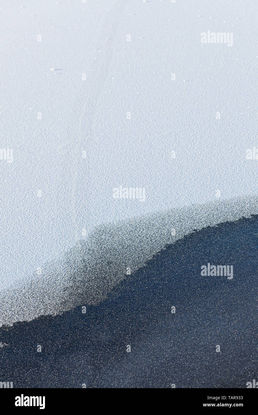 Snow on frozen lake ice surface background Stock Photo - Alamy