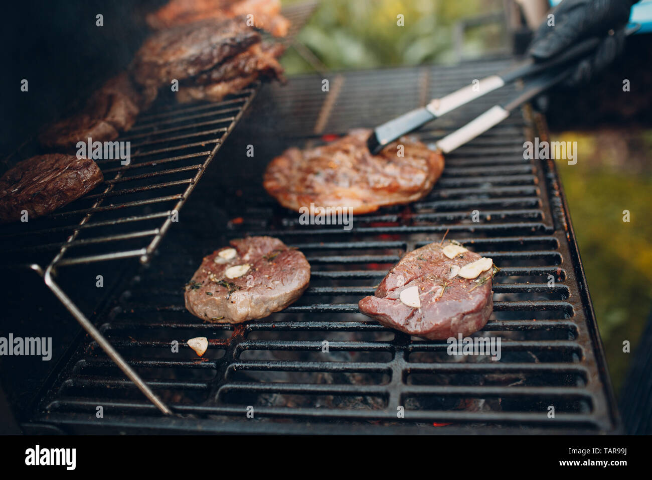 Grilled meat on the grill outdoor Stock Photo - Alamy