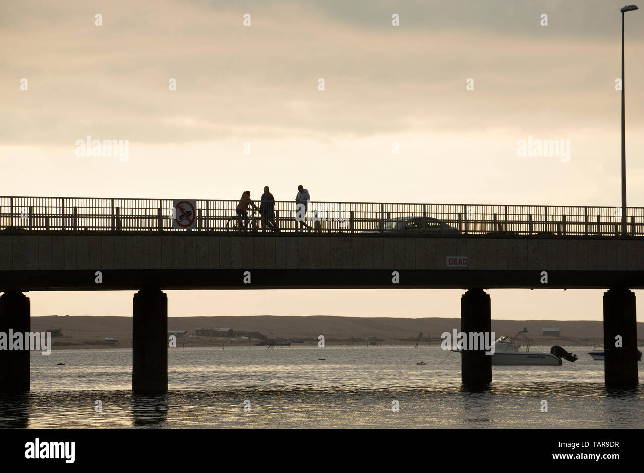 A cyclist and pedestrians crossing the bridge at Ferry Bridge in the ...