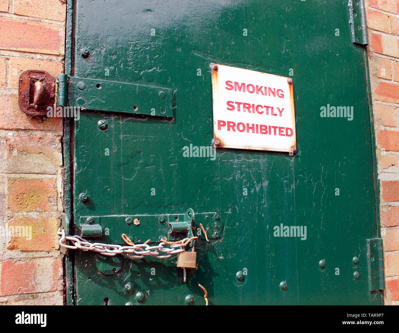 Heavy door chained and padlocked for security Stock Photo - Alamy