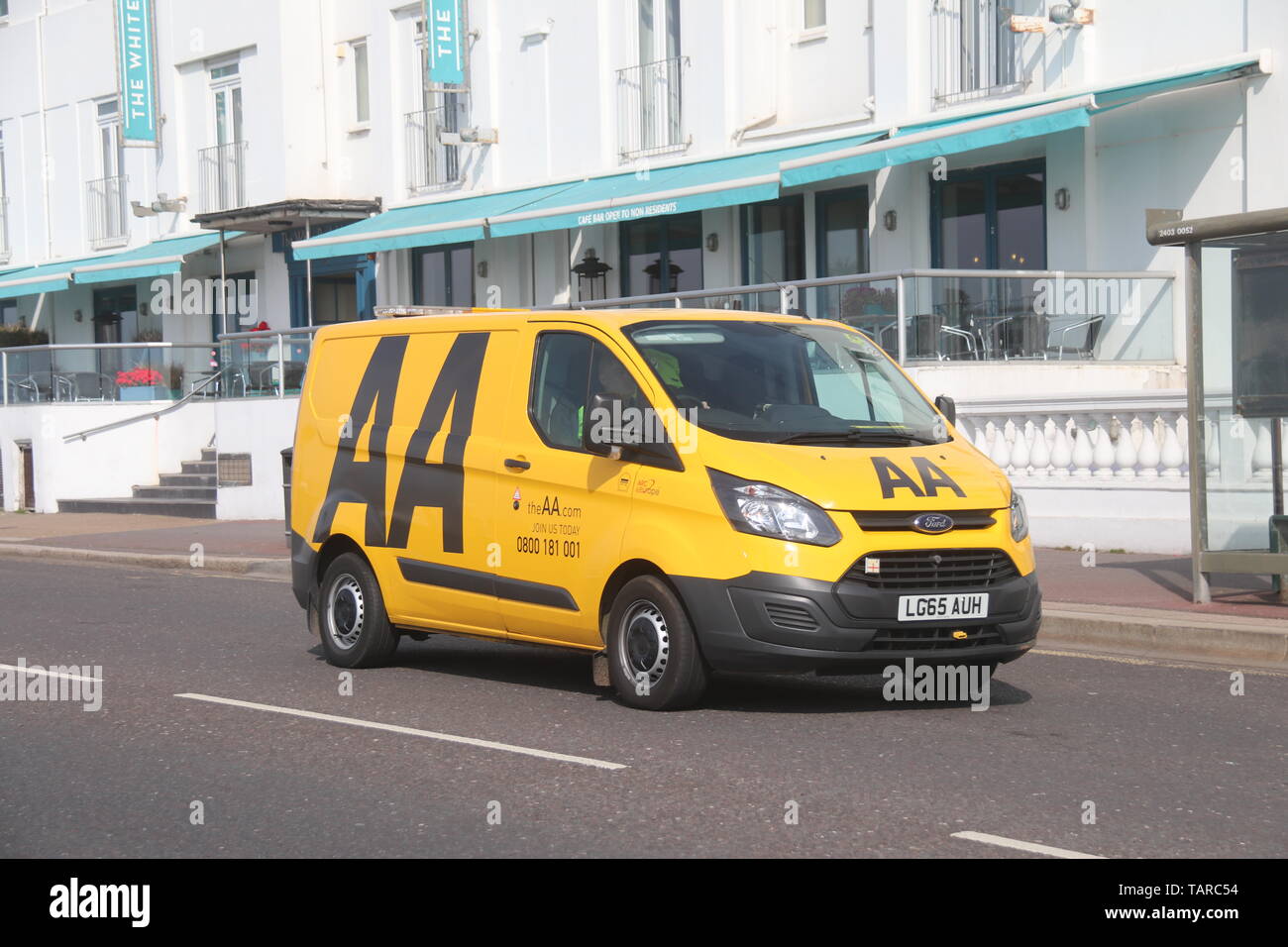 AN AA AUTOMOBILE ASSOCIATION FORD TRANSIT VAN DRIVING ALONG AN URBAN ...