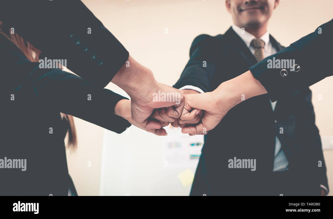 Four Fist bump in business meeting for team concept Stock Photo - Alamy