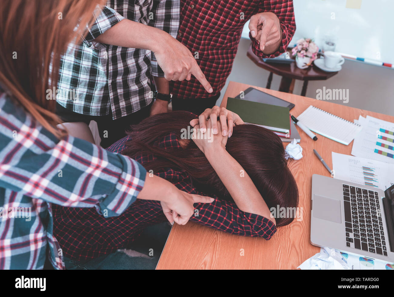 Casual office workers is blaming on upset team mate Stock Photo - Alamy