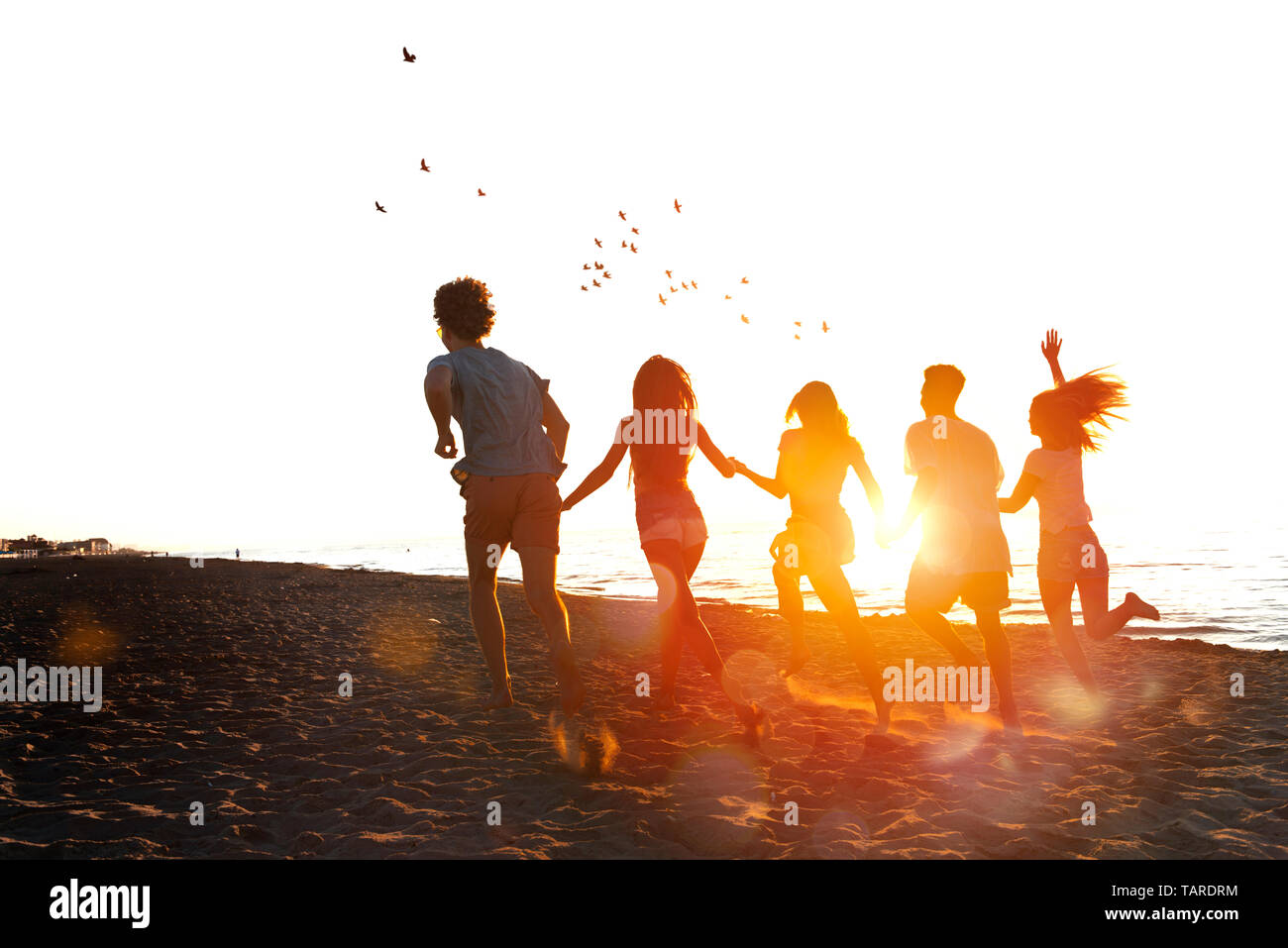Group running into sea hi-res stock photography and images - Alamy