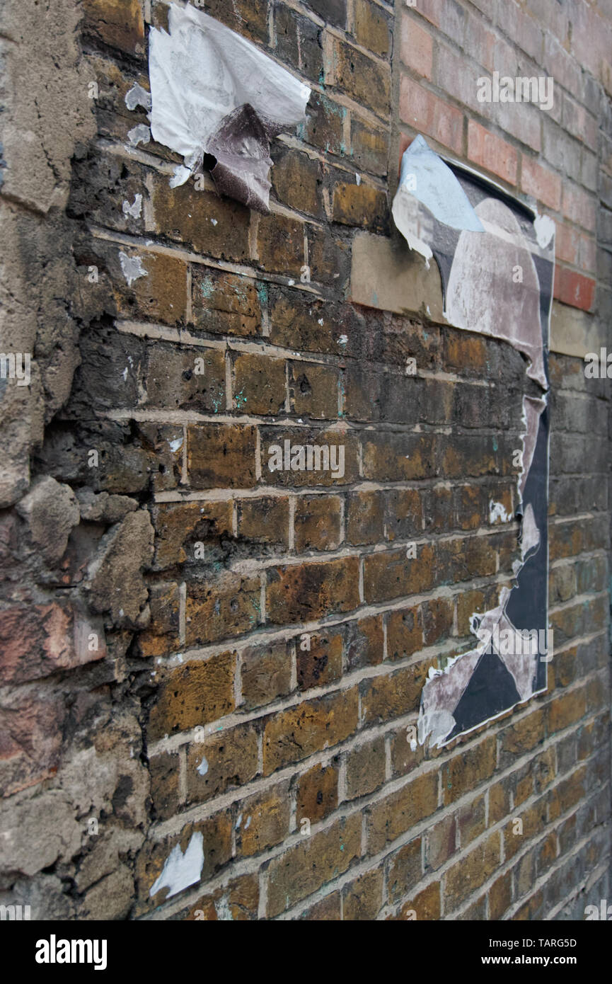 Diminishing perspective view of an exposed weathered brick wall with ...