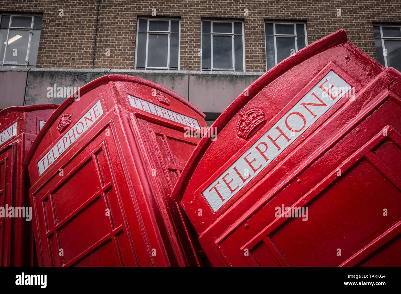 David Mach's row of 'Out of Order' red tumbling telephone boxes on Old ...