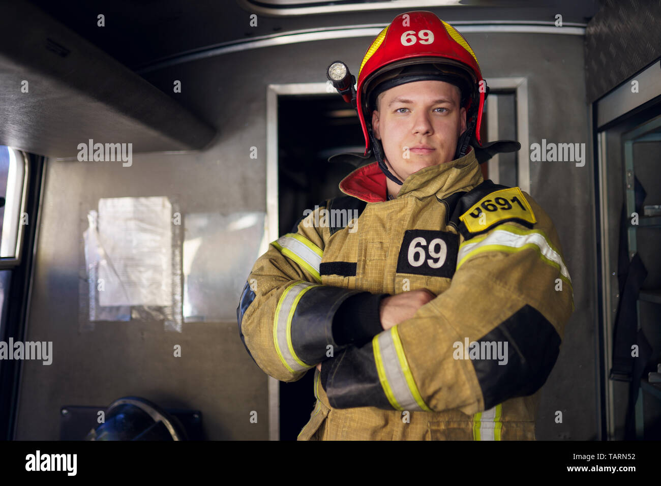Photo of man fireman on background of fire truck at fire station Stock ...