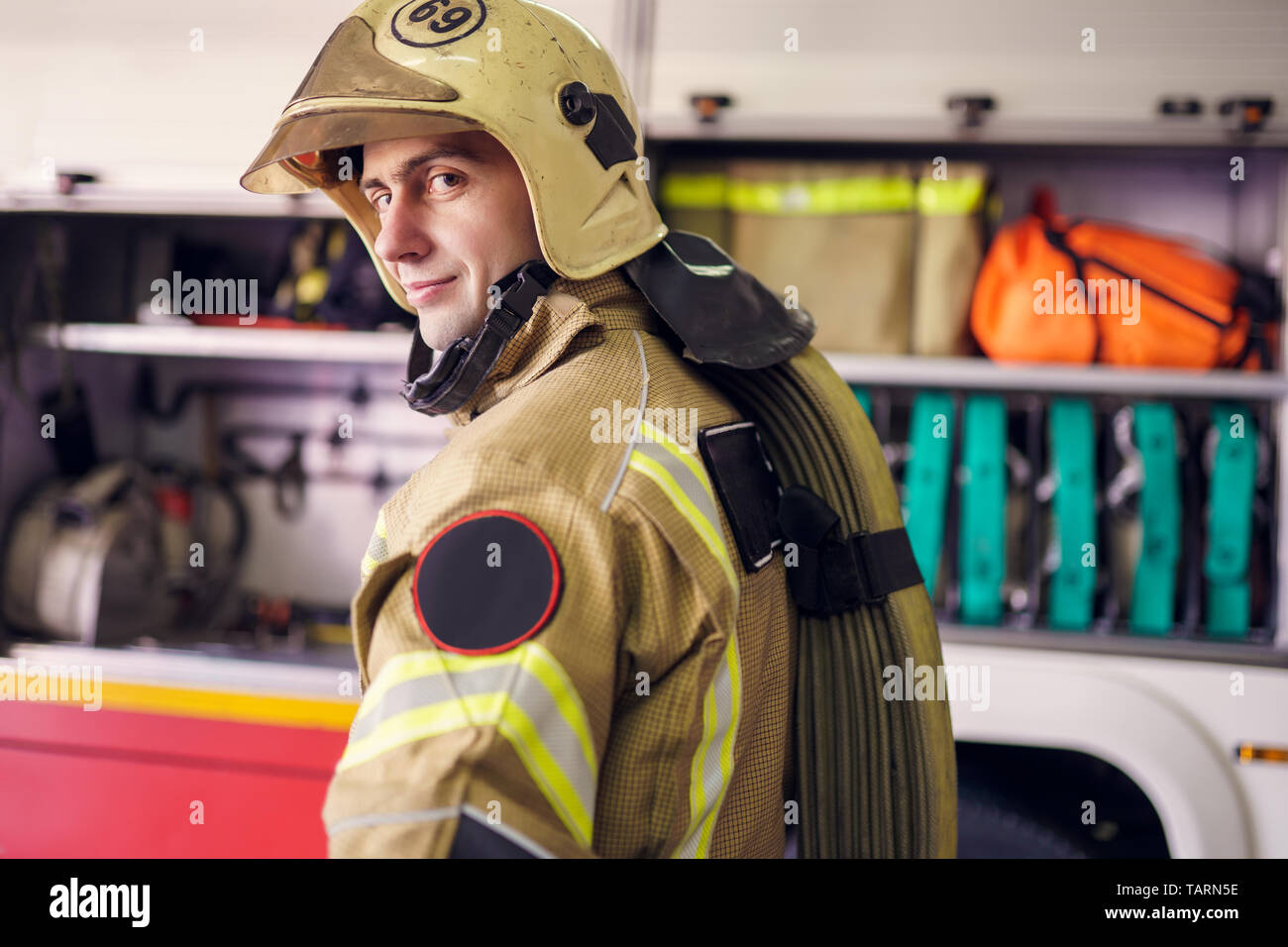 Image of man fireman in helmet on background of fire truck at fire ...