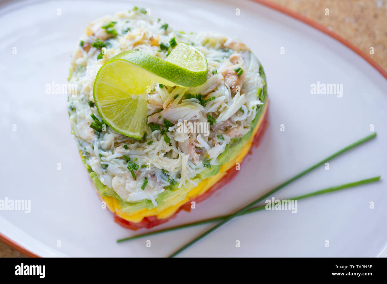 A homemade spider crab meat stack made in a heart-shaped mould ...