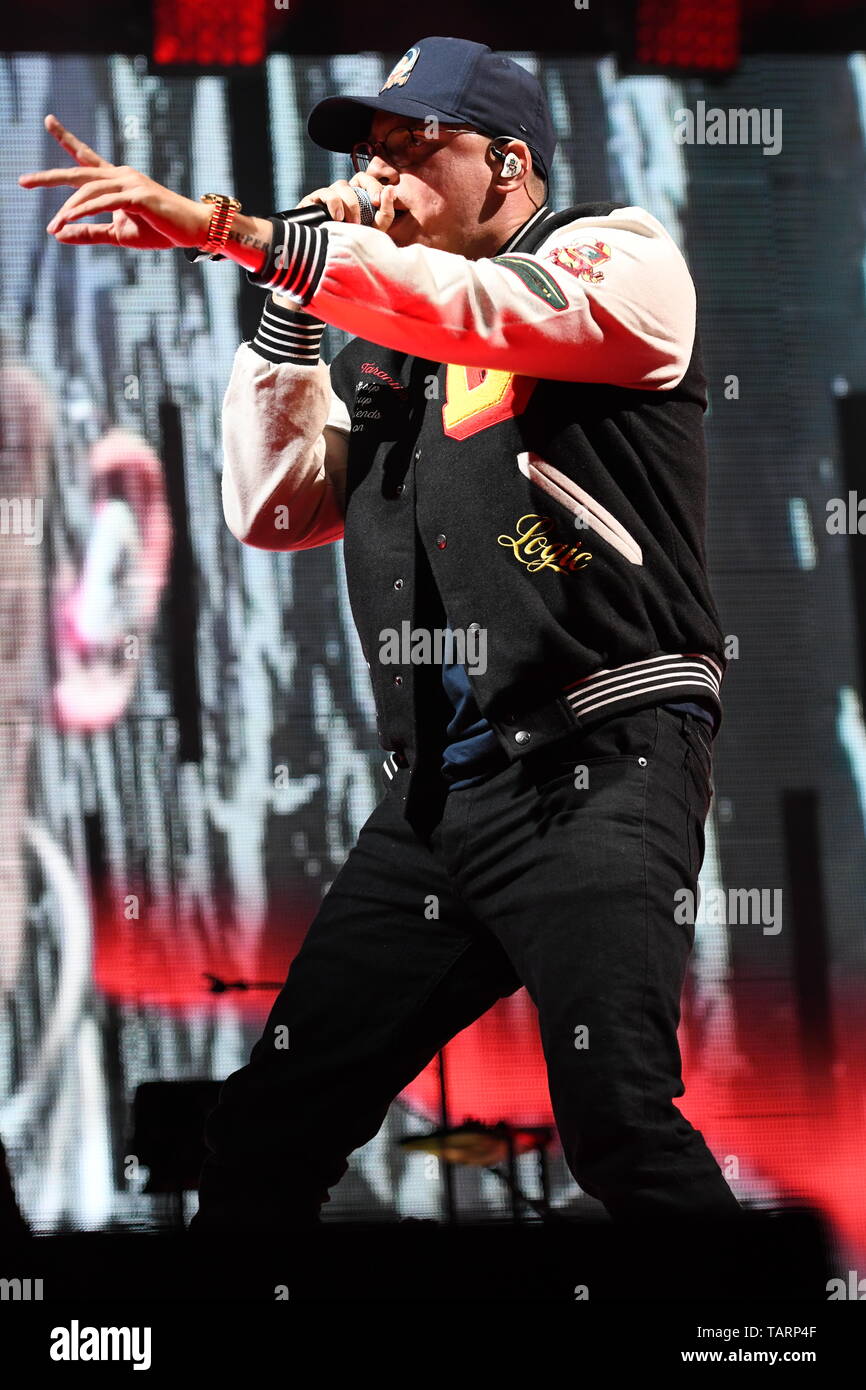 Rapper Logic is shown performing on stage during a live concert ...