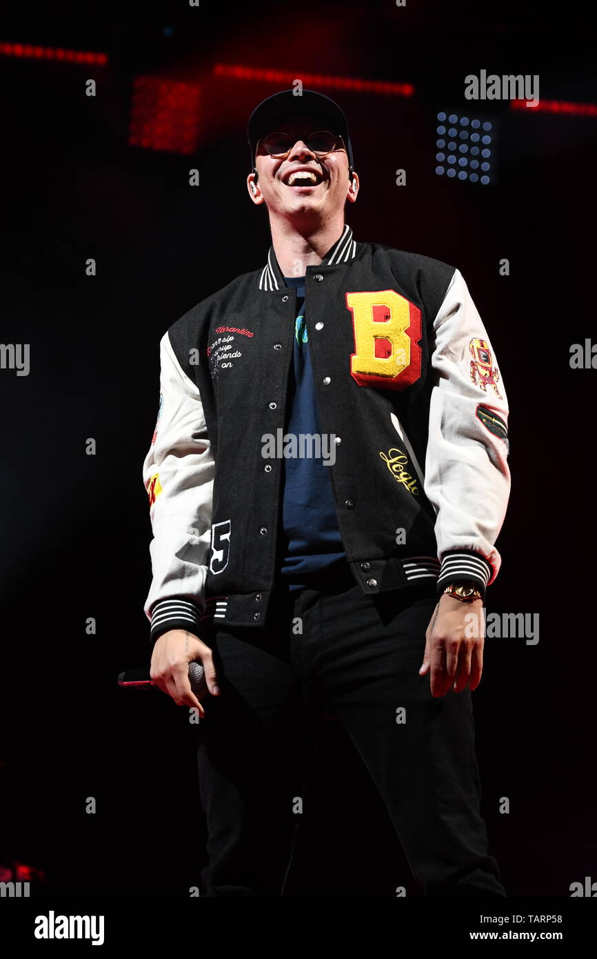 Rapper Logic is shown performing on stage during a live concert ...