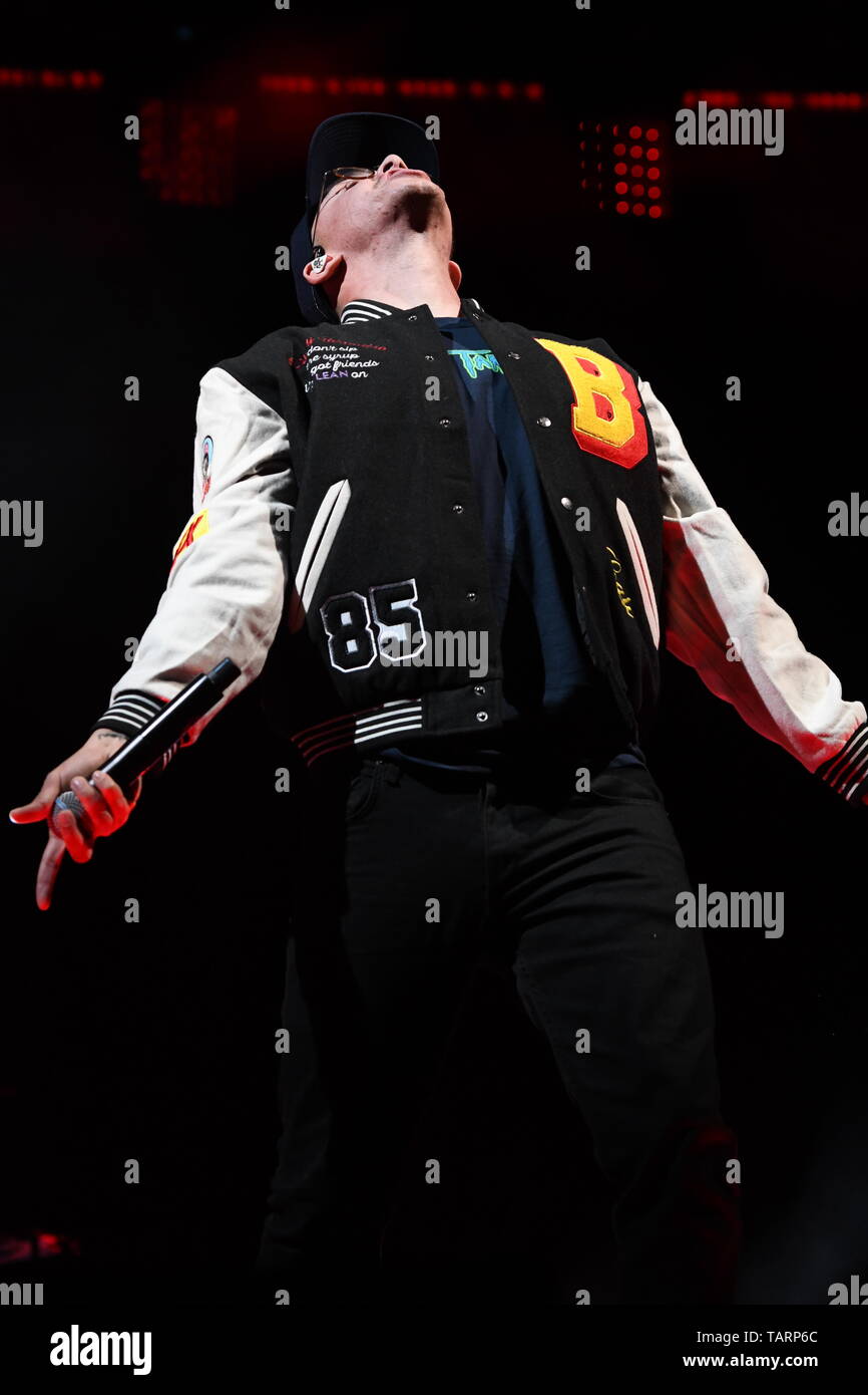 Rapper Logic is shown performing on stage during a live concert ...