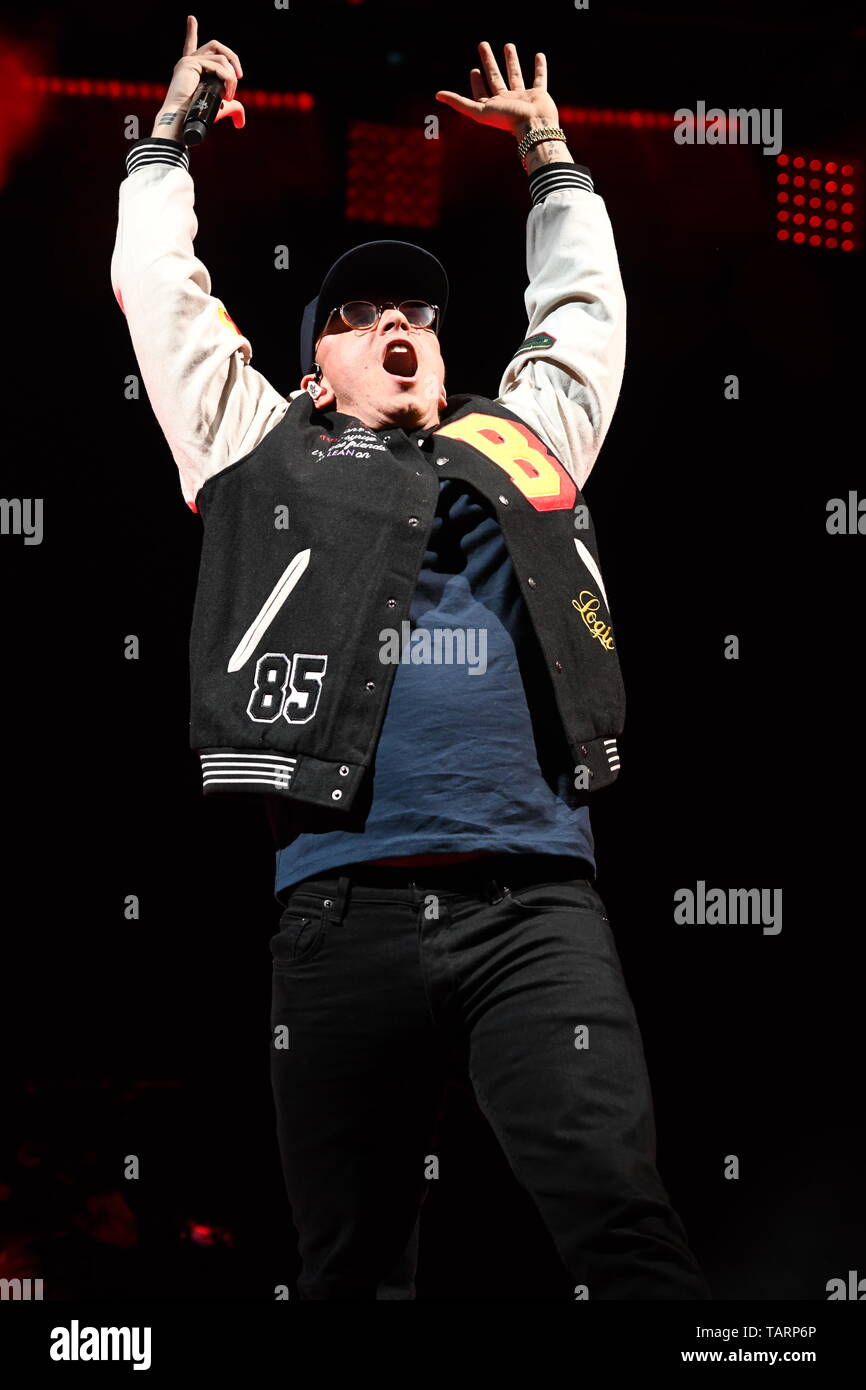 Rapper Logic is shown performing on stage during a live concert ...