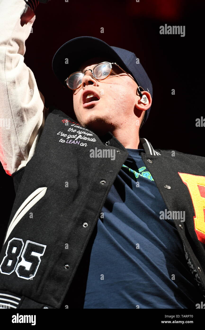 Rapper Logic is shown performing on stage during a live concert ...
