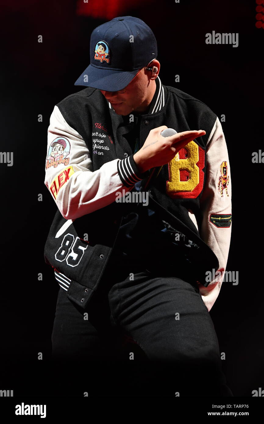 Rapper Logic is shown performing on stage during a live concert ...