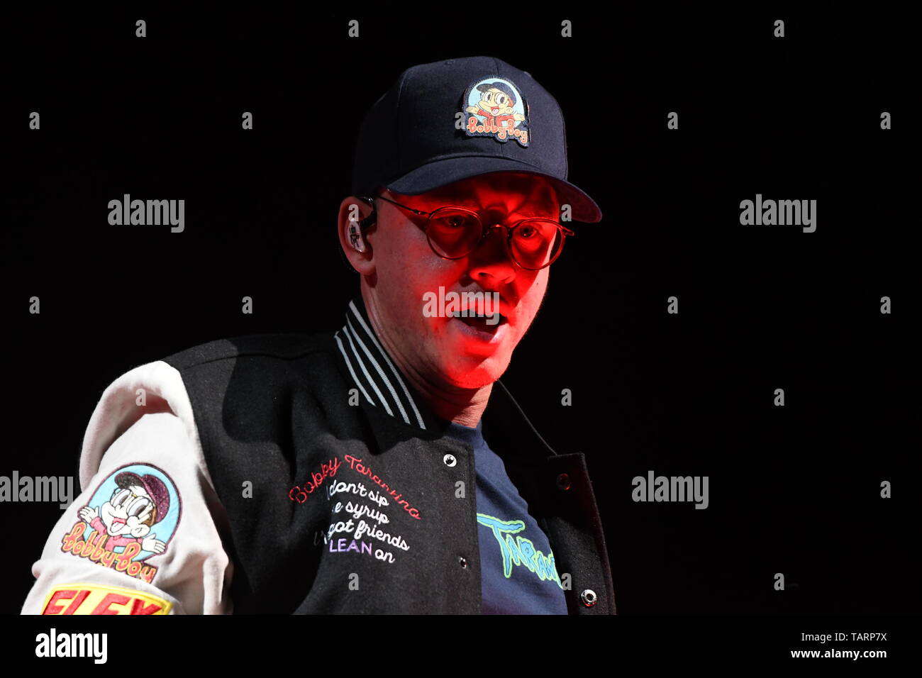 Rapper Logic is shown performing on stage during a live concert ...