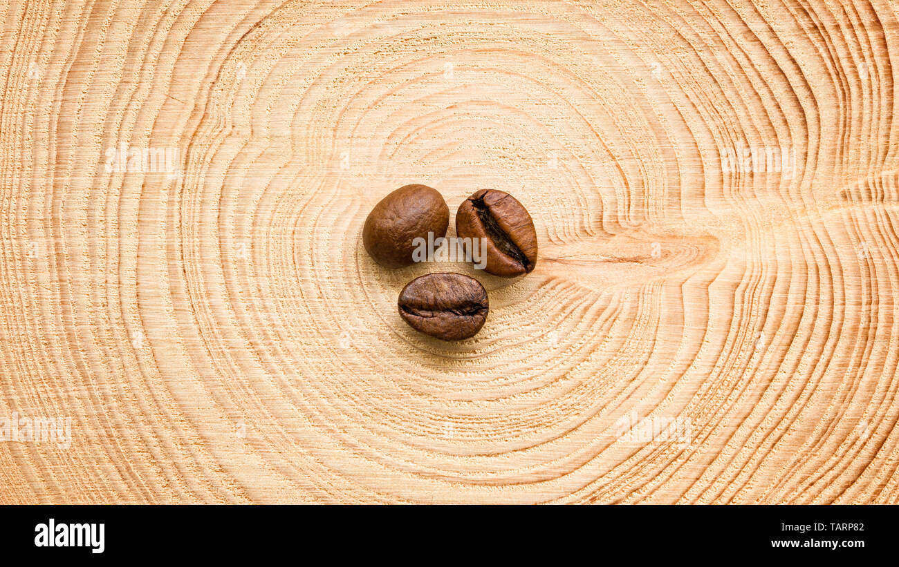 Coffee beans on natural wooden texture background. Coffee background or ...