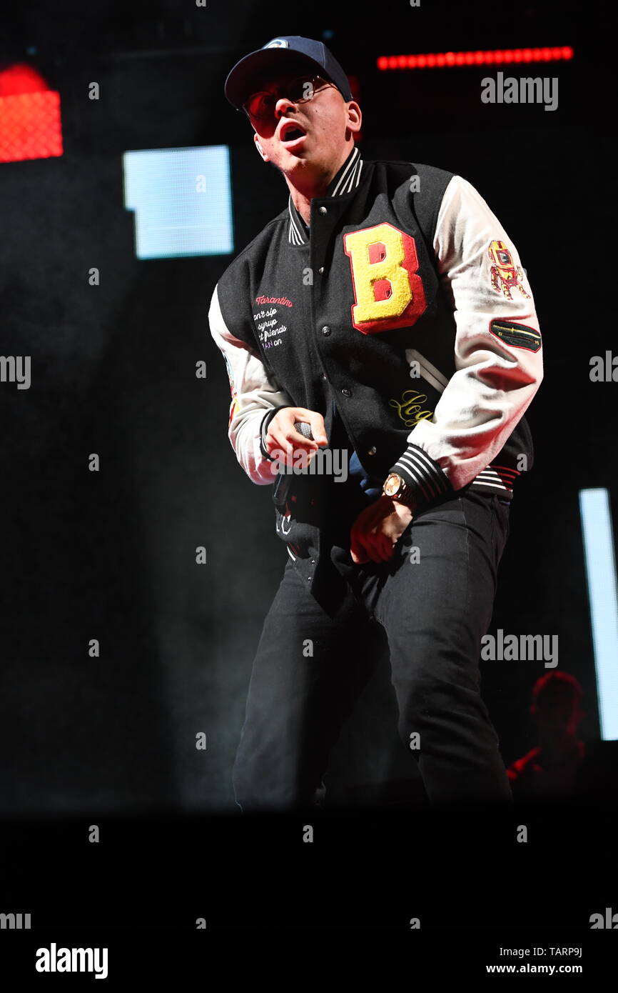 Rapper Logic is shown performing on stage during a live concert ...