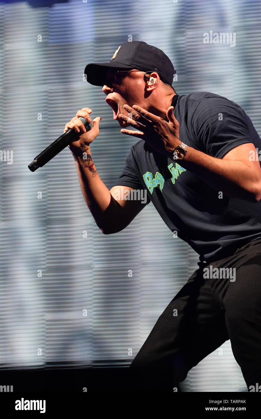 Rapper Logic is shown performing on stage during a live concert ...