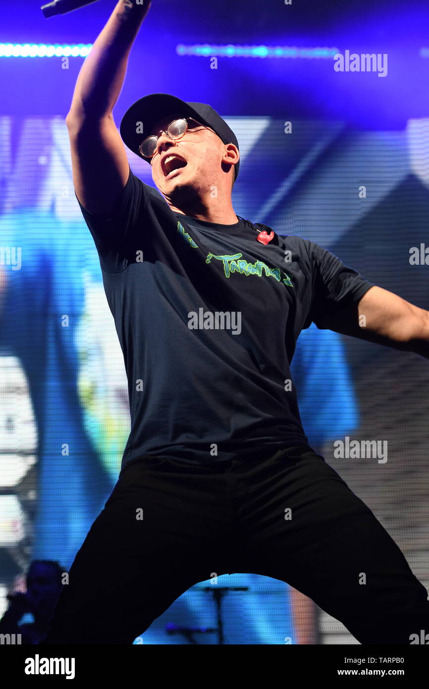 Rapper Logic is shown performing on stage during a live concert ...