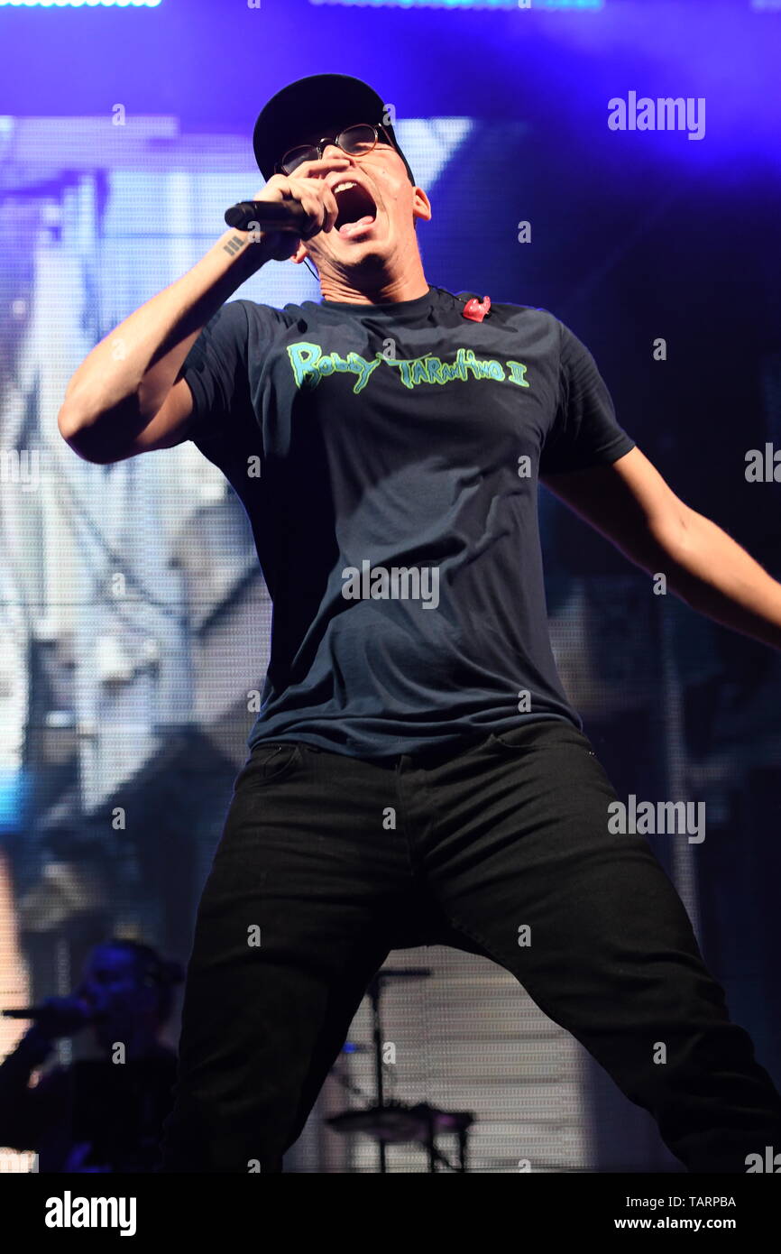 Rapper Logic is shown performing on stage during a live concert ...