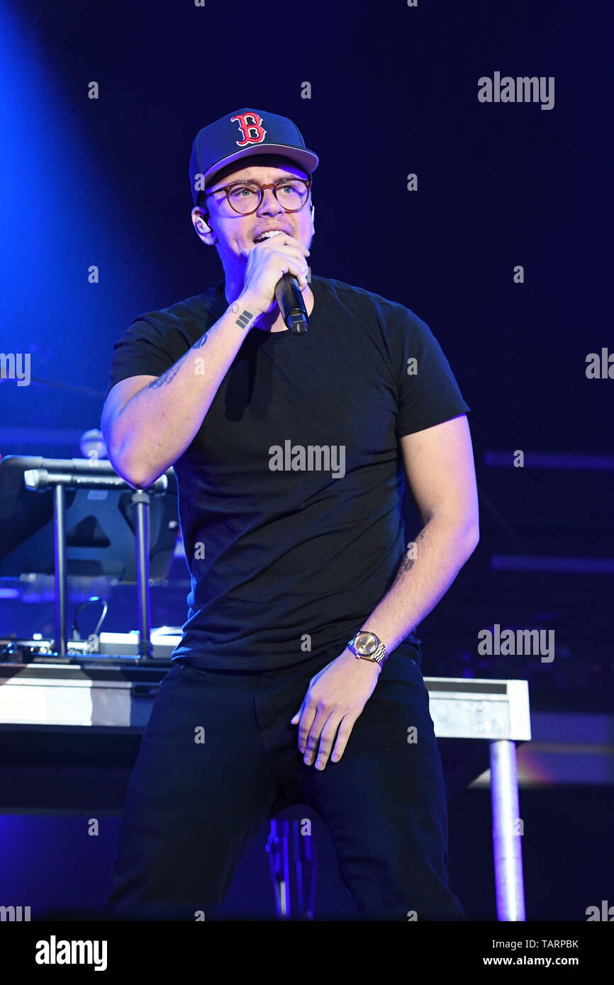 Rapper Logic is shown performing on stage during a live concert ...