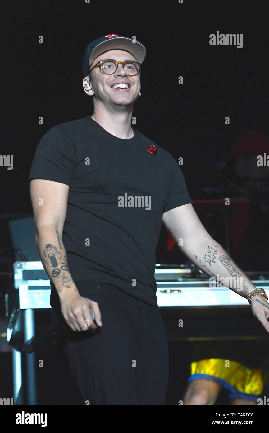 Rapper Logic is shown performing on stage during a live concert ...