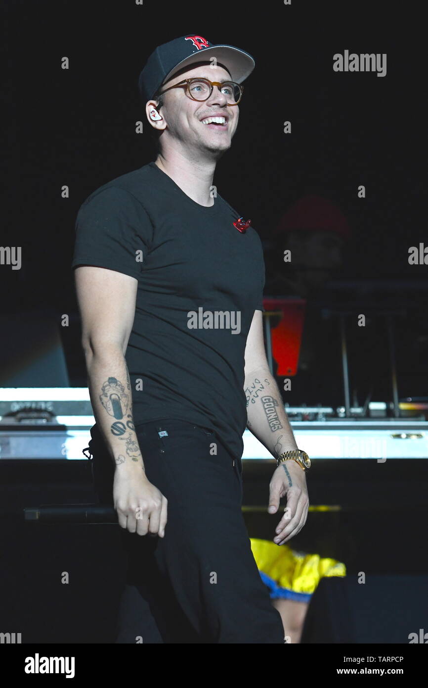 Rapper Logic is shown performing on stage during a live concert ...