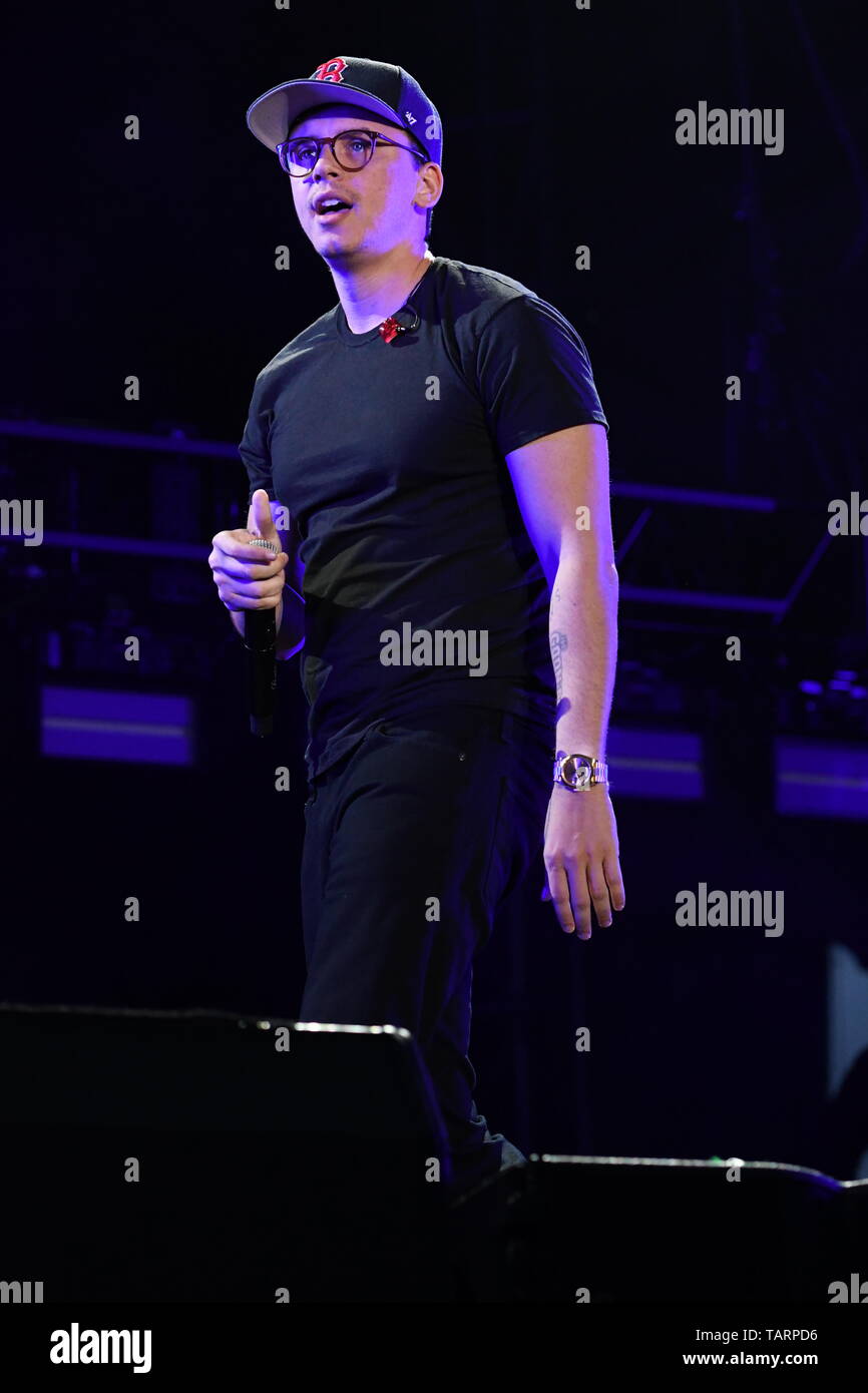 Rapper Logic is shown performing on stage during a live concert ...