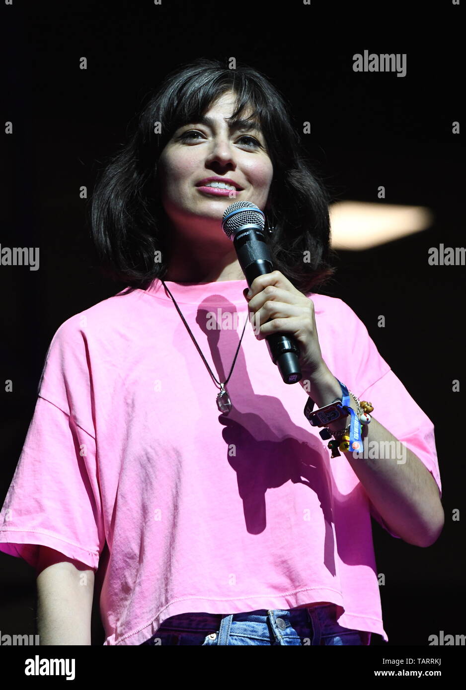Comedian Melissa Villaseñor is shown performing on stage during a "live ...