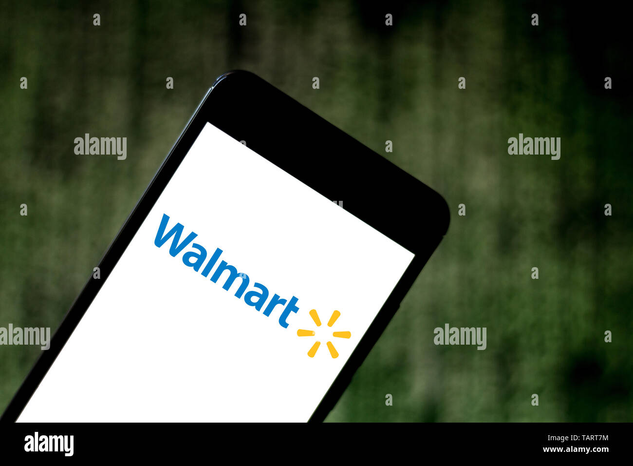 In this photo illustration the Walmart Stores logo is seen displayed on ...